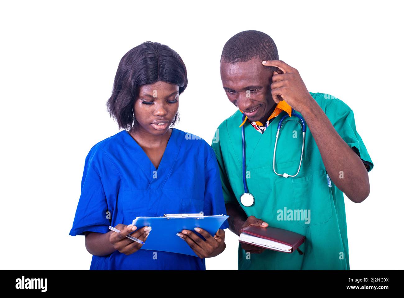 Doctor and nurse checking patient medical reports on clipboard at ...