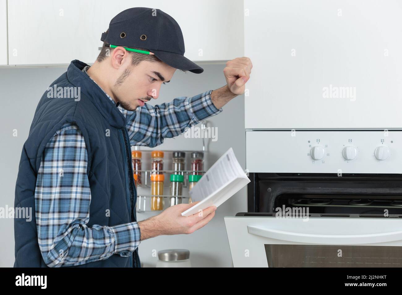 contractor reading fitting instructions for new oven Stock Photo - Alamy