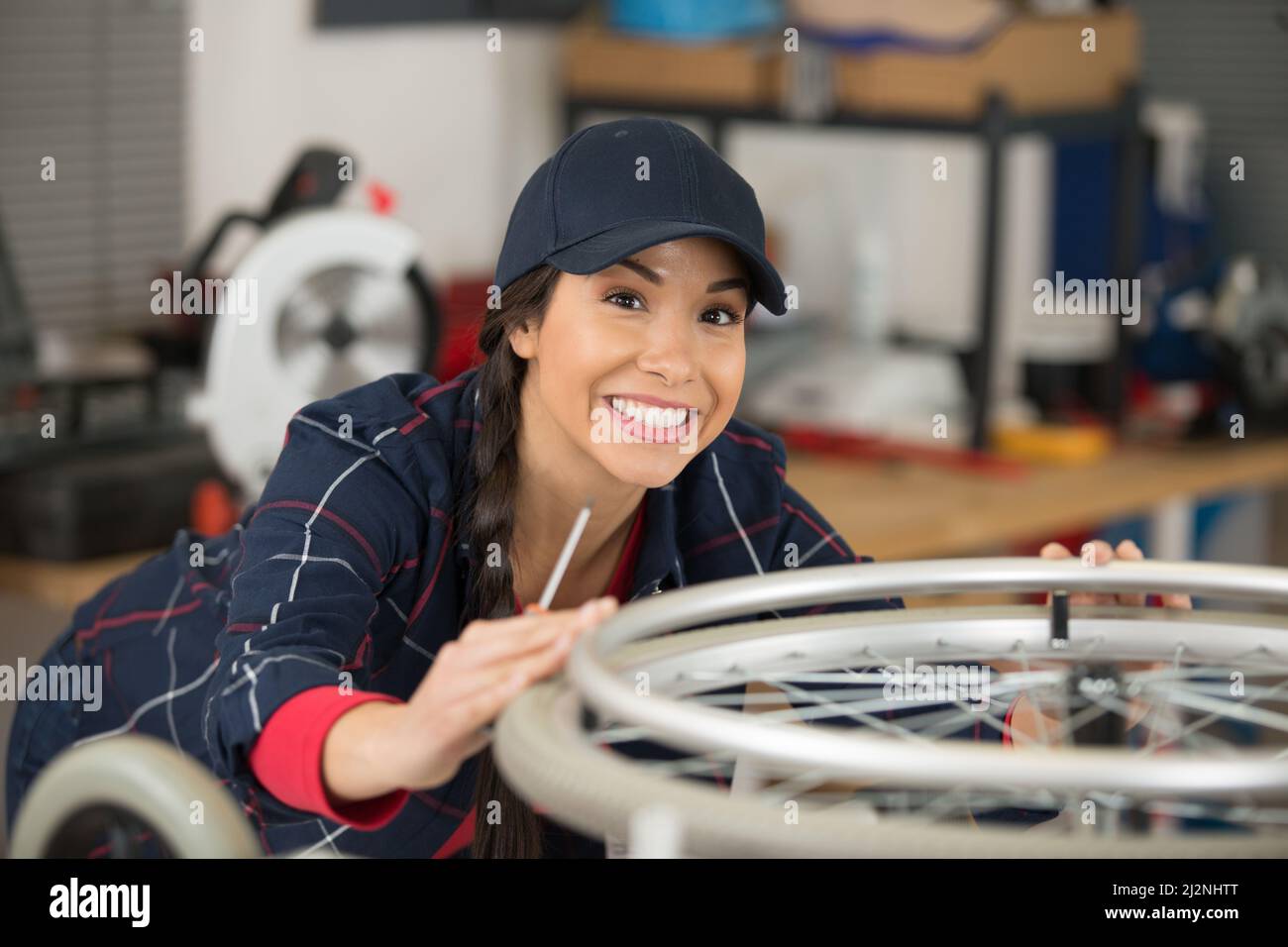 female repairing a wheelchair Stock Photo - Alamy