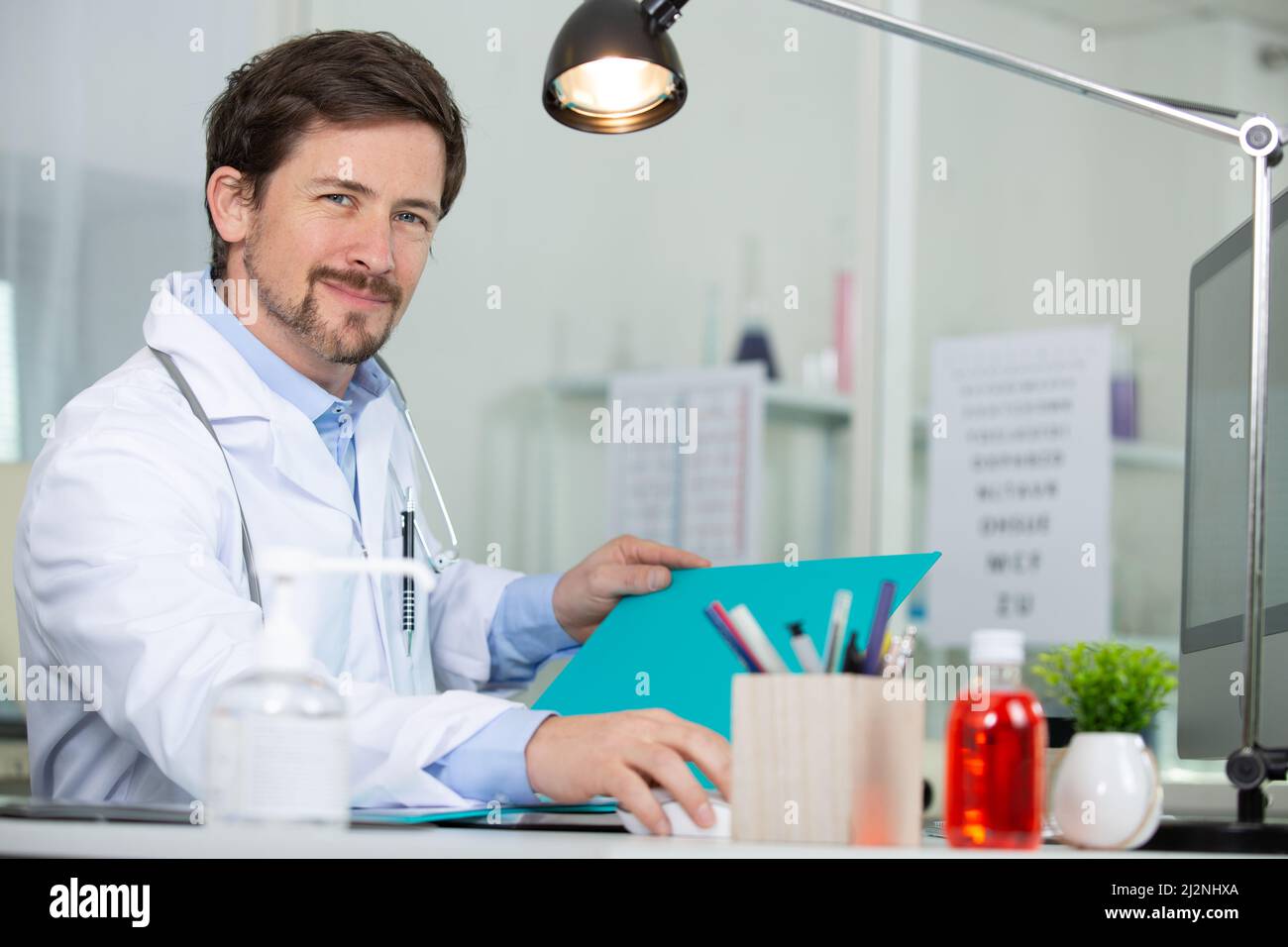 Caucasian male doctor using desktop hi-res stock photography and images ...