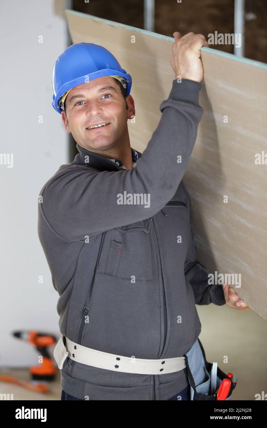 Builder carrying wood on shoulder hi-res stock photography and images ...
