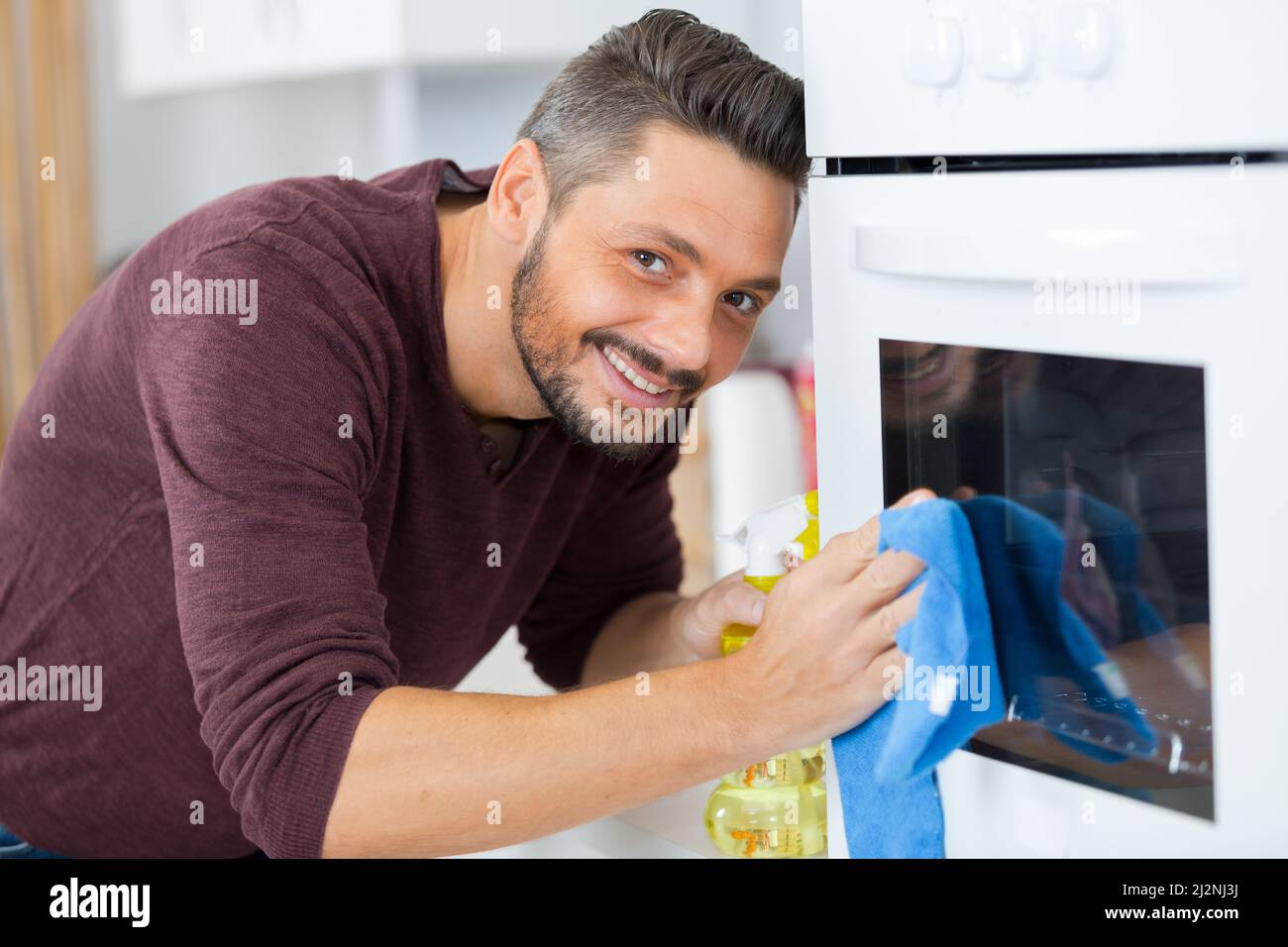 Man cleaning oven in kitchen hi-res stock photography and images - Alamy