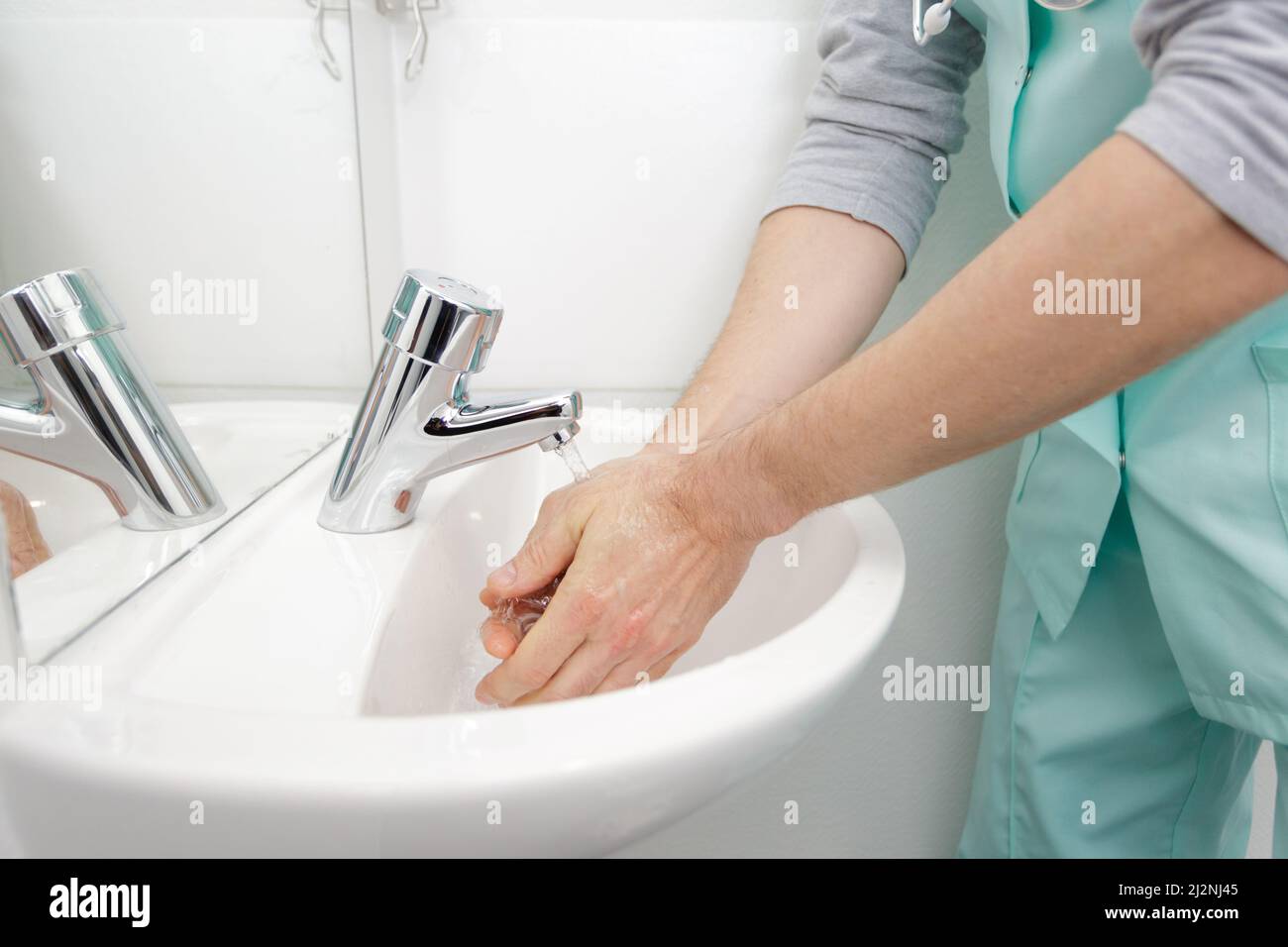 doctor washing hands at medical clinic sink Stock Photo - Alamy