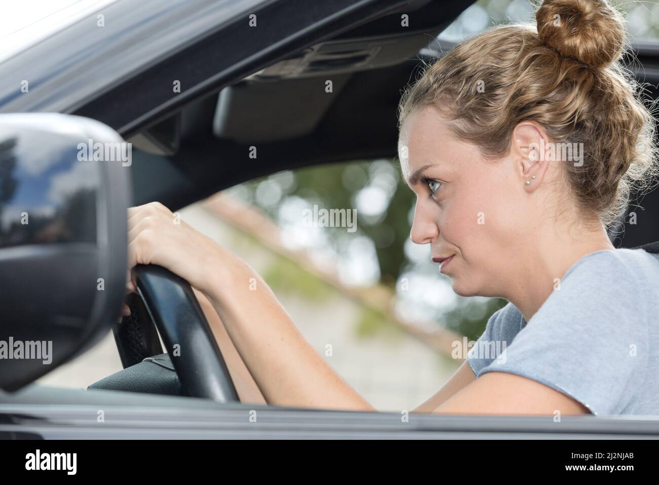 side view of woman focused on her driving Stock Photo - Alamy