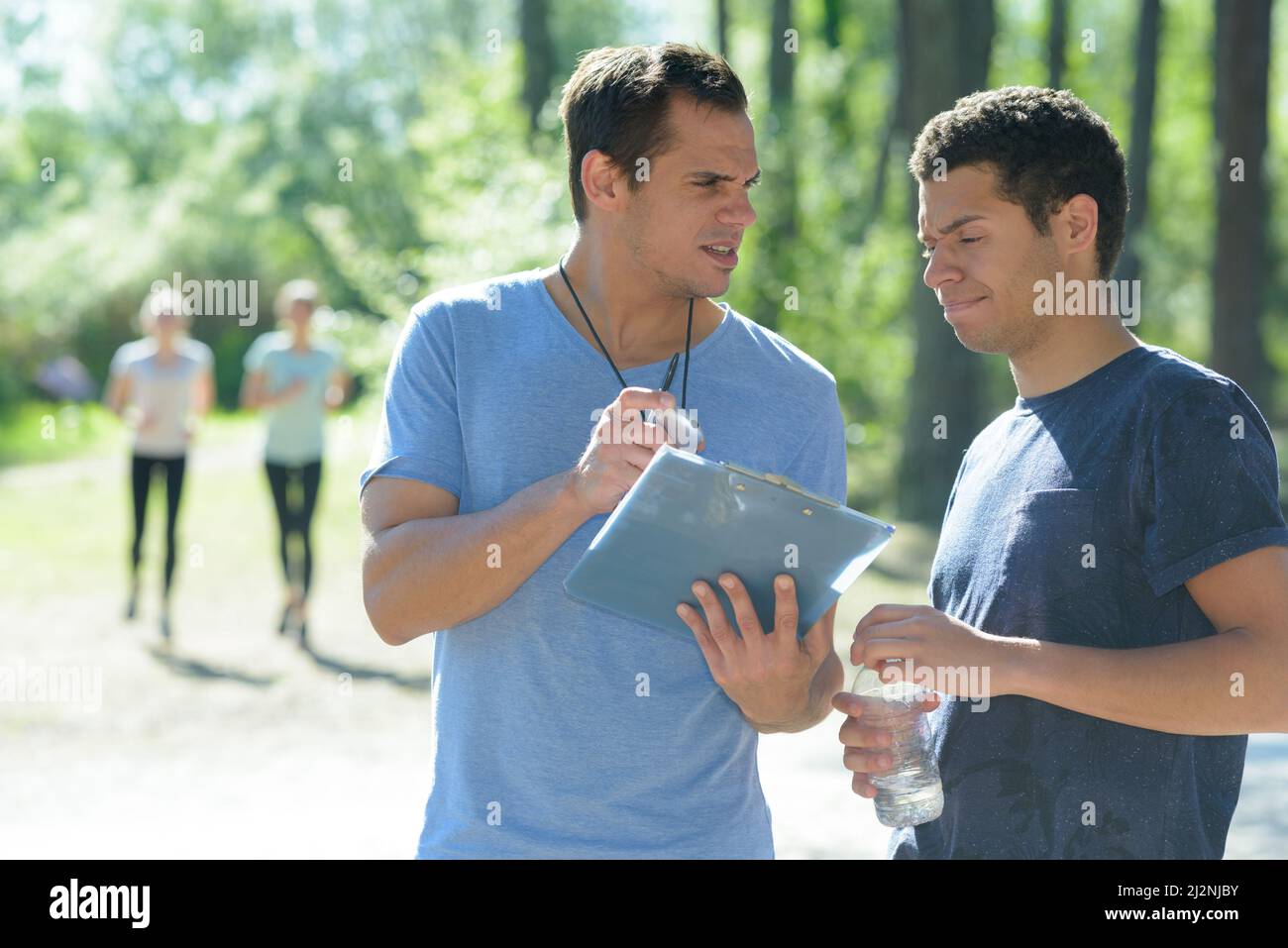 Runner talking to coach hi-res stock photography and images - Alamy