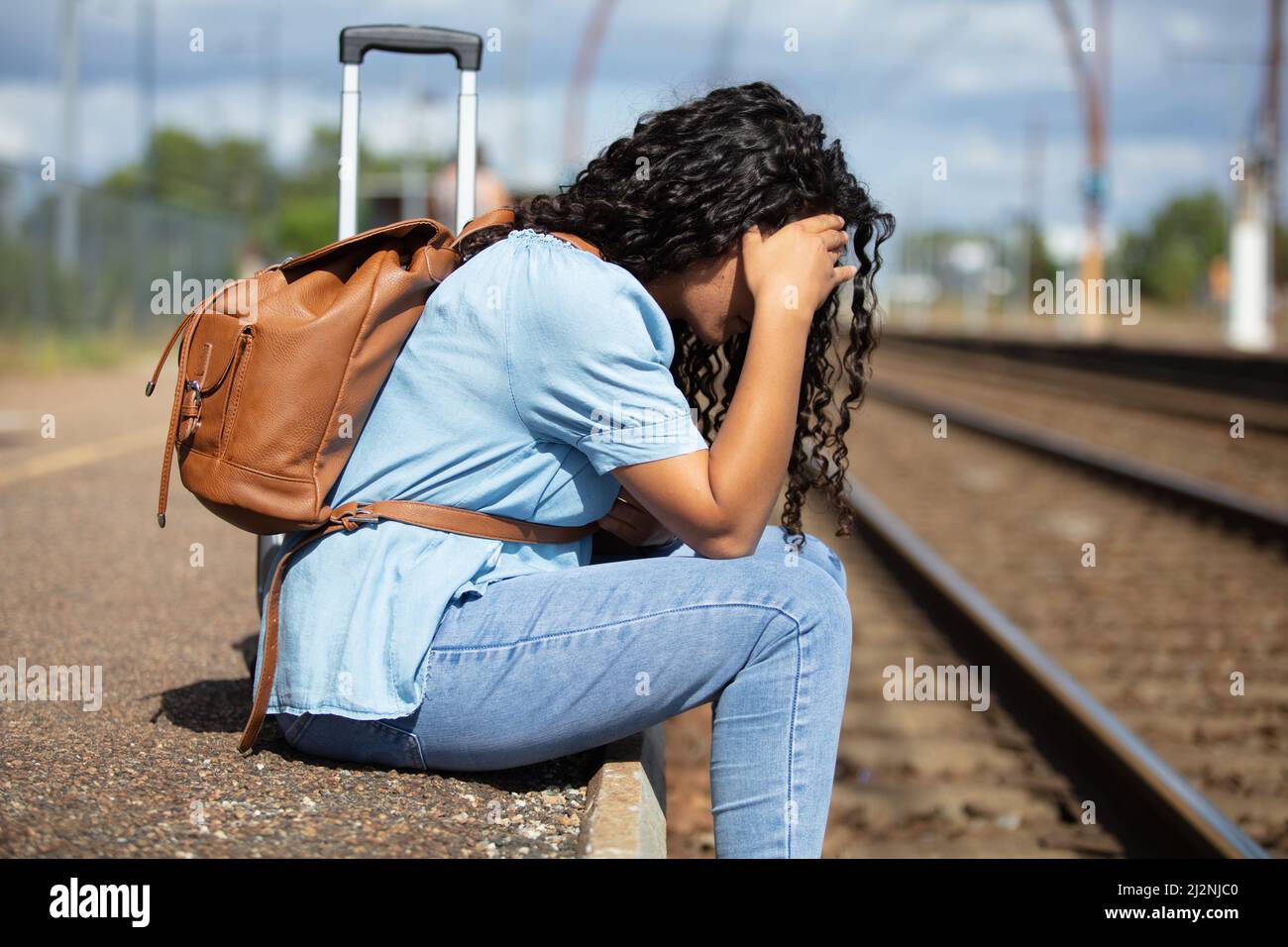 sad lonely young woman on railway track with suitcase Stock Photo - Alamy