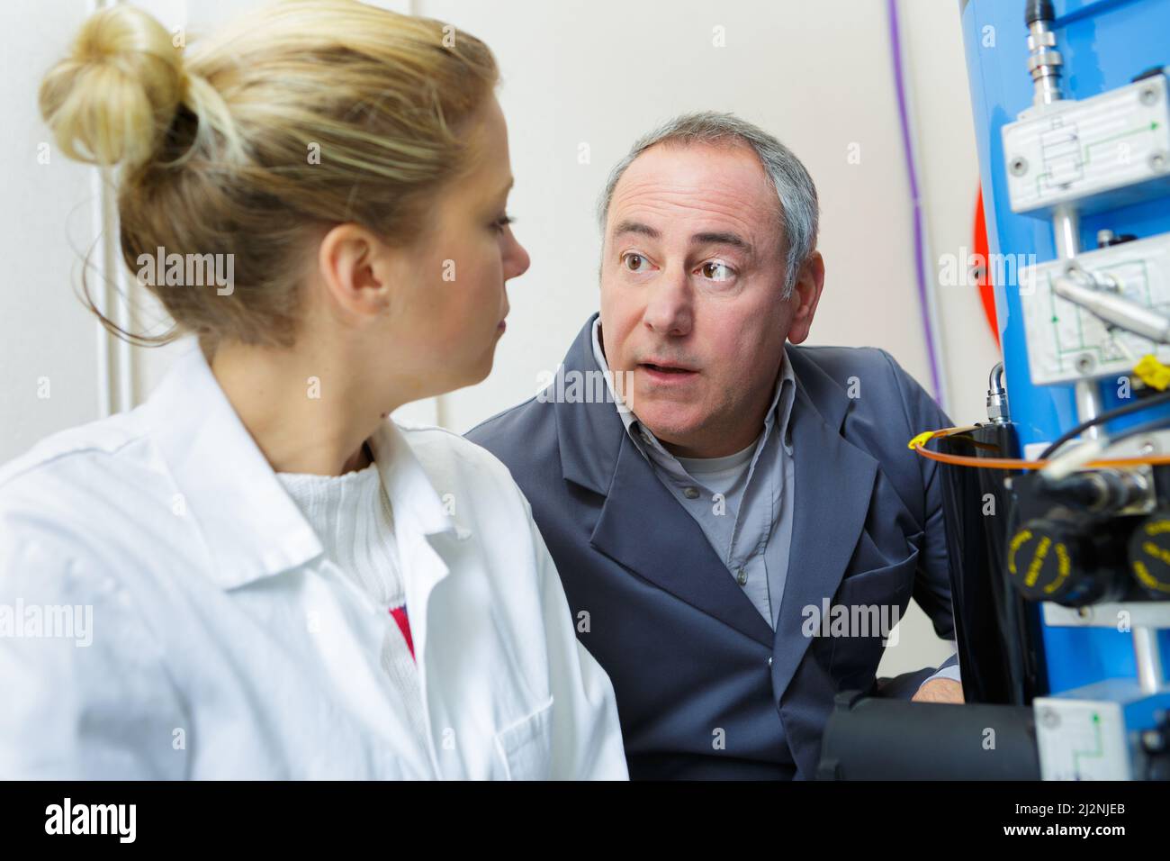 colleagues using manufacturing machines in lab Stock Photo - Alamy