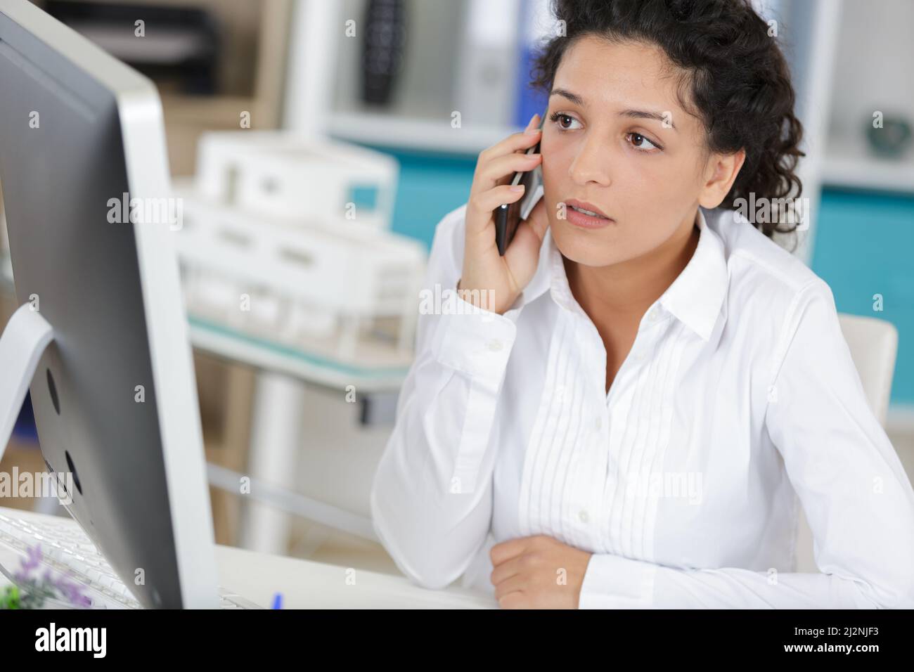 woman on phone in busy modern office Stock Photo - Alamy