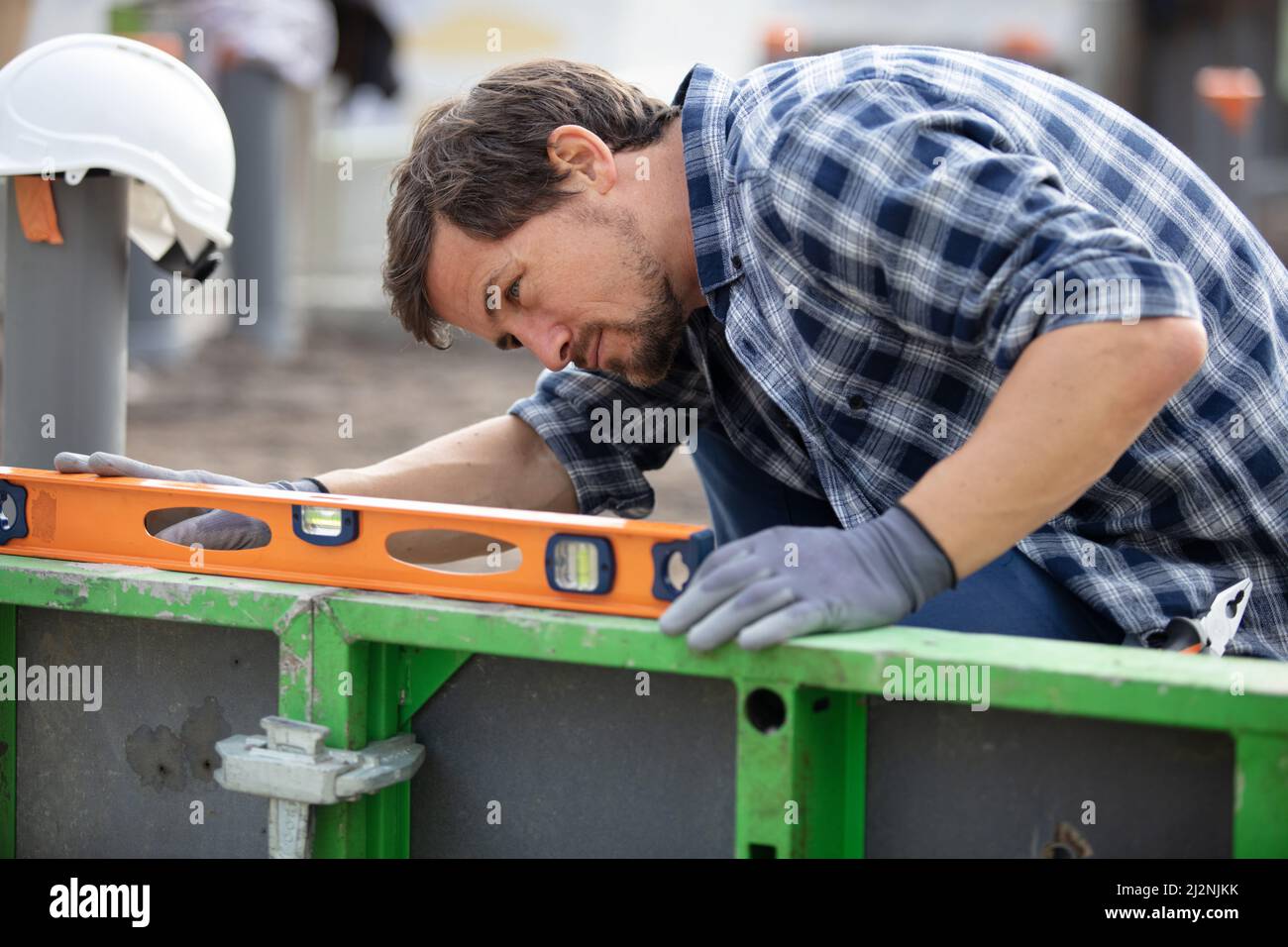worker using spirit level on wall Stock Photo - Alamy