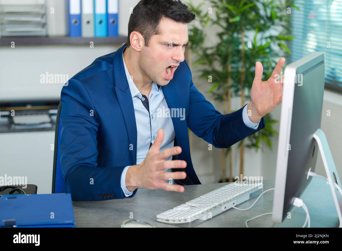 male office worker shouting on the computer screen Stock Photo - Alamy