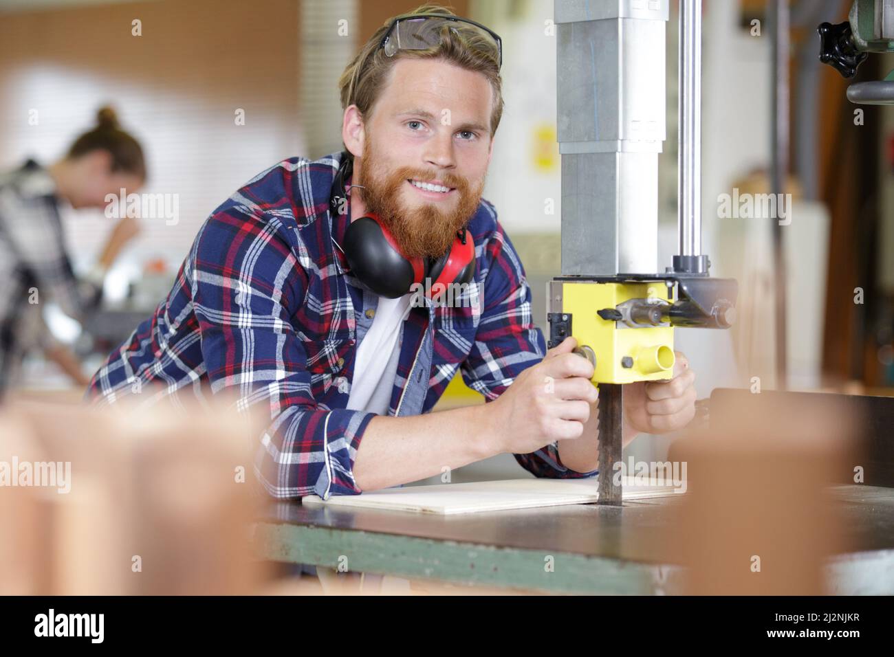 carpenter adjusting blade on bench saw Stock Photo - Alamy