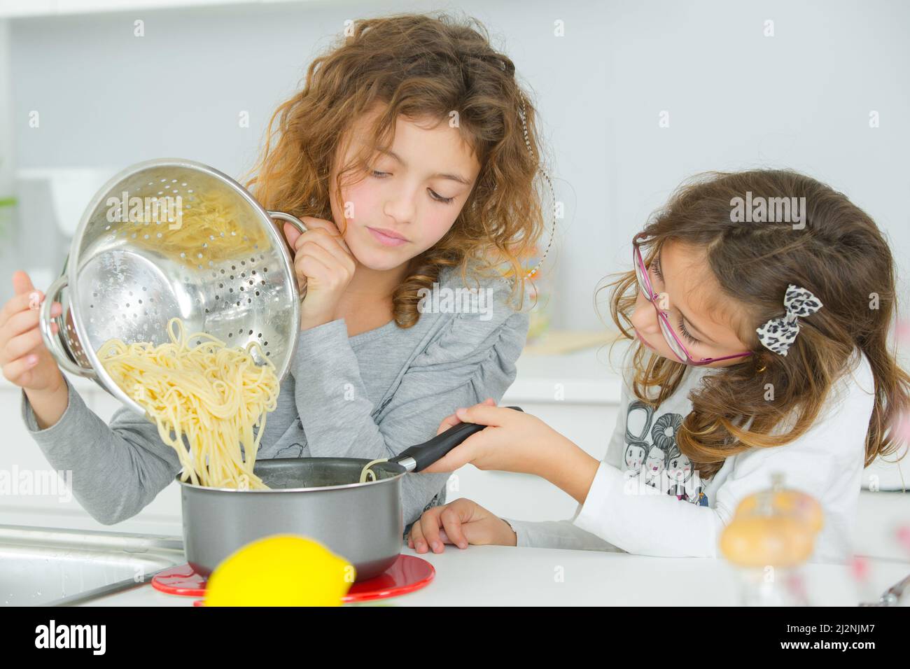 two sisters are cooking together Stock Photo - Alamy