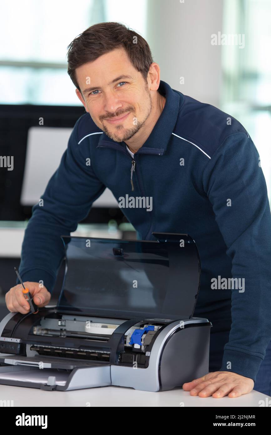 hardware repairman repairing broken printer fax machine Stock Photo - Alamy