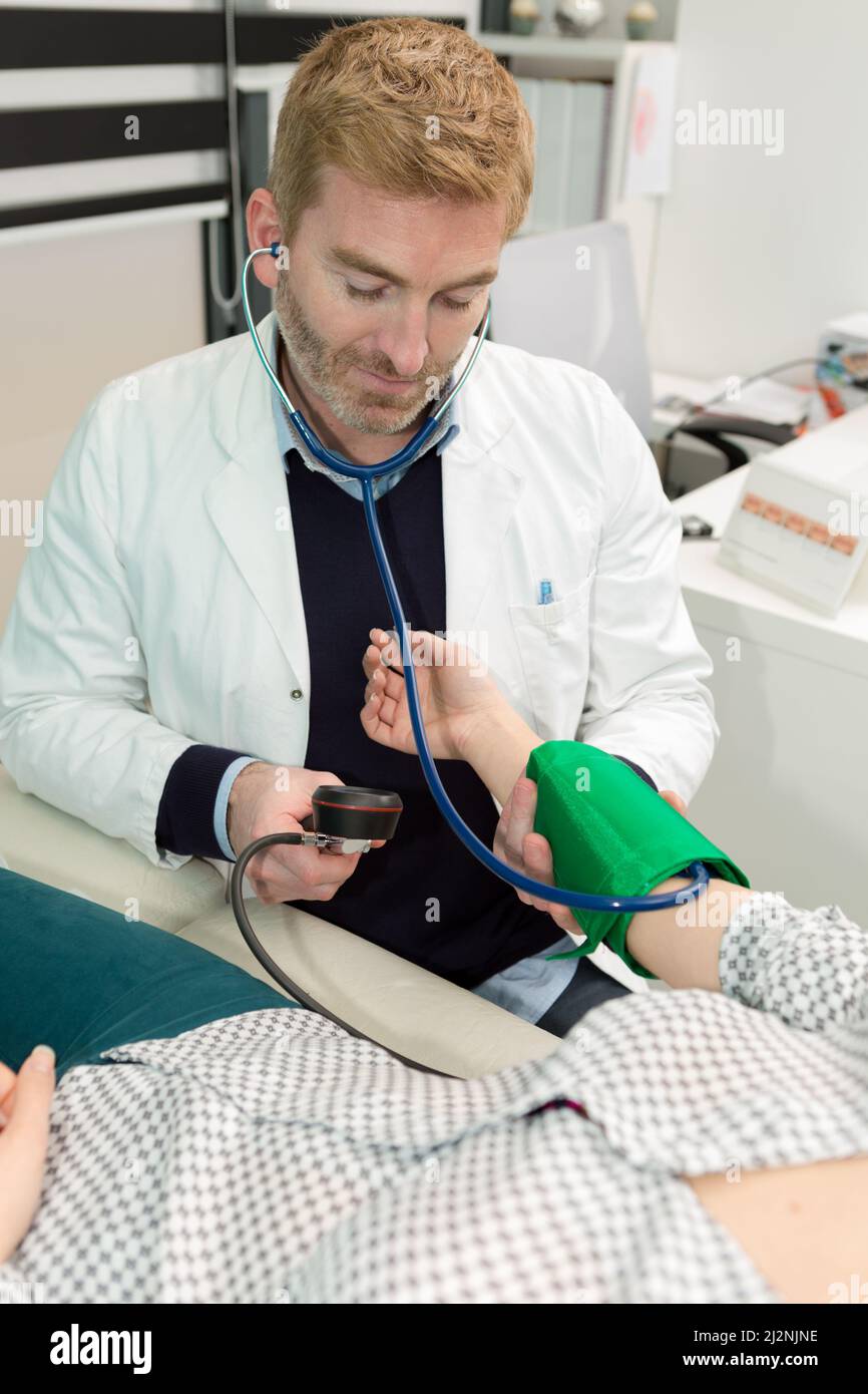 doctor checking old man patient arterial blood pressure Stock Photo - Alamy