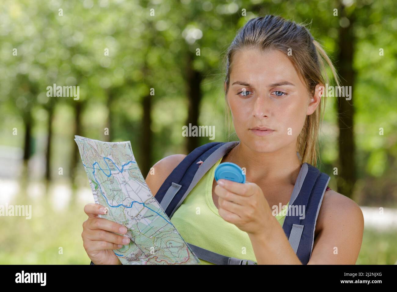 woman traveling using map and compass in nature Stock Photo - Alamy