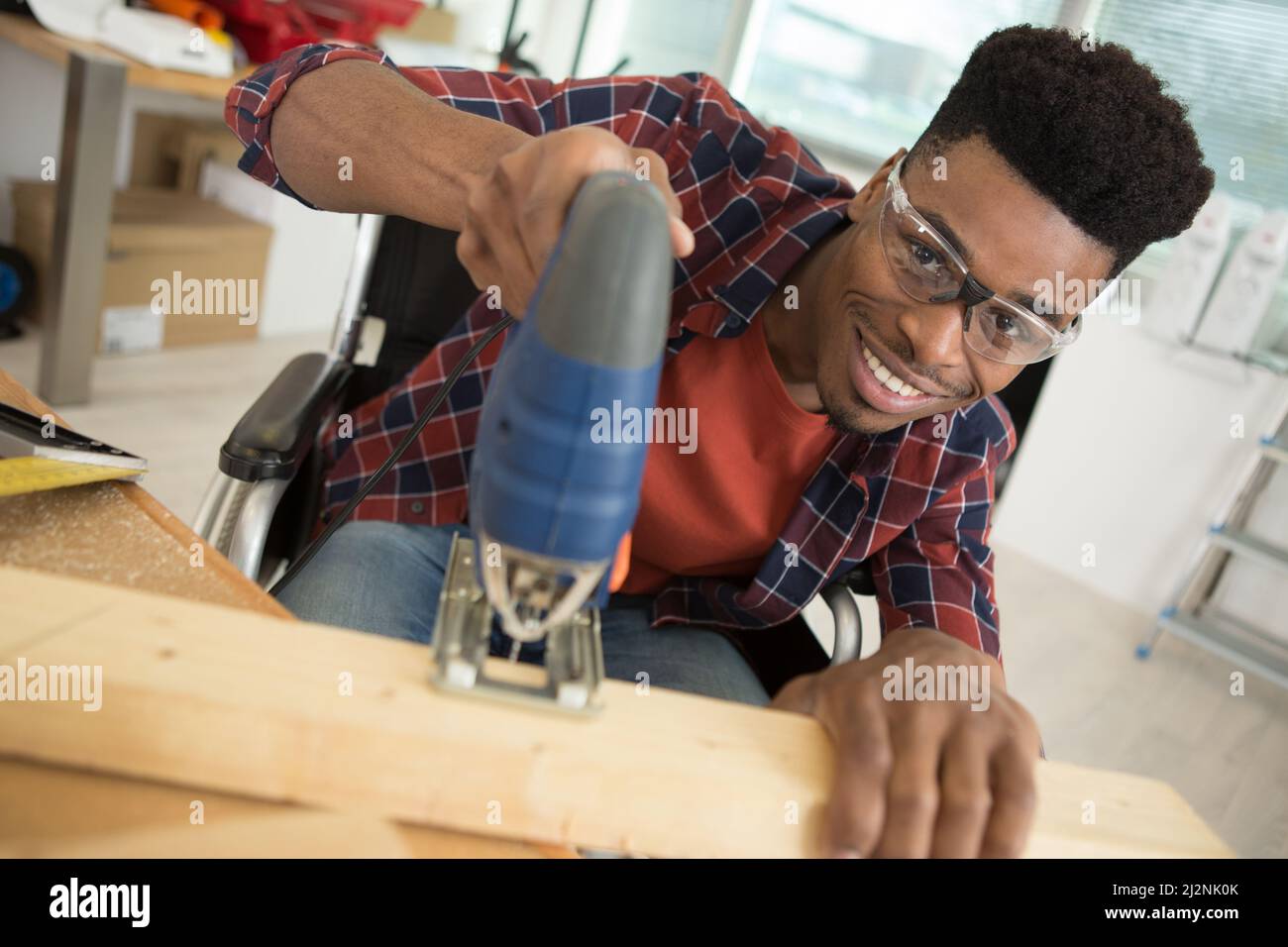 male carpenter in a wheelchair using a jigsaw Stock Photo - Alamy