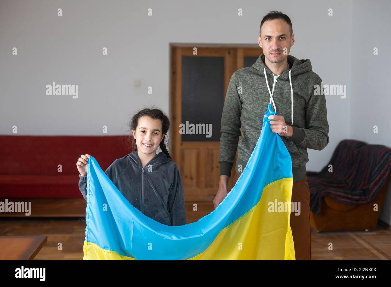 Father with daughter holding Ukrainian flag. Peace and pray for Ukraine ...