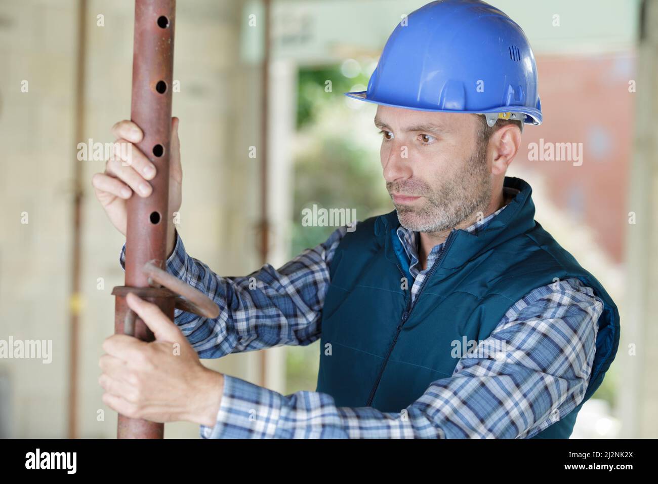 male builder checking the airduct installation Stock Photo - Alamy