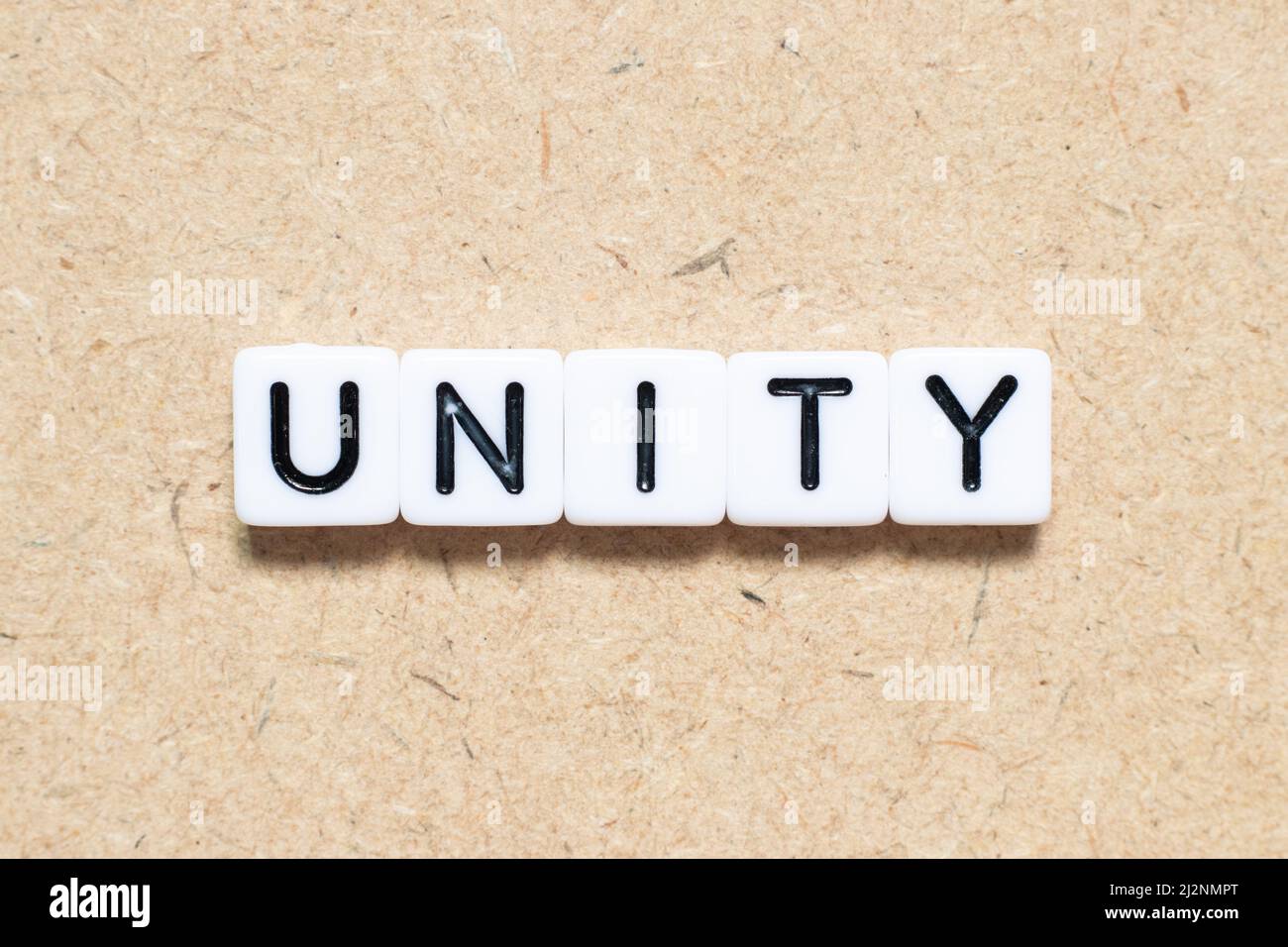 White tile alphabet letter with word unity on wood background Stock ...