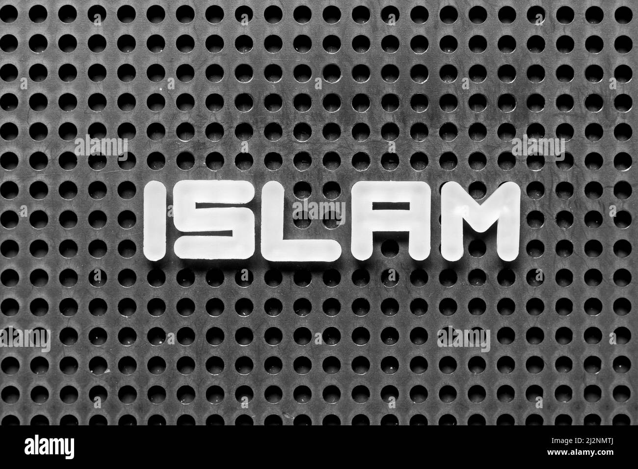 White alphabet letter in word islam on black pegboard background Stock ...