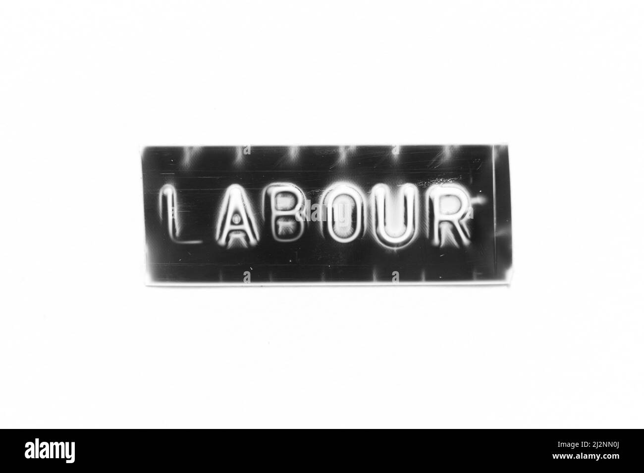 Black color banner that have embossed letter with word labour on white ...