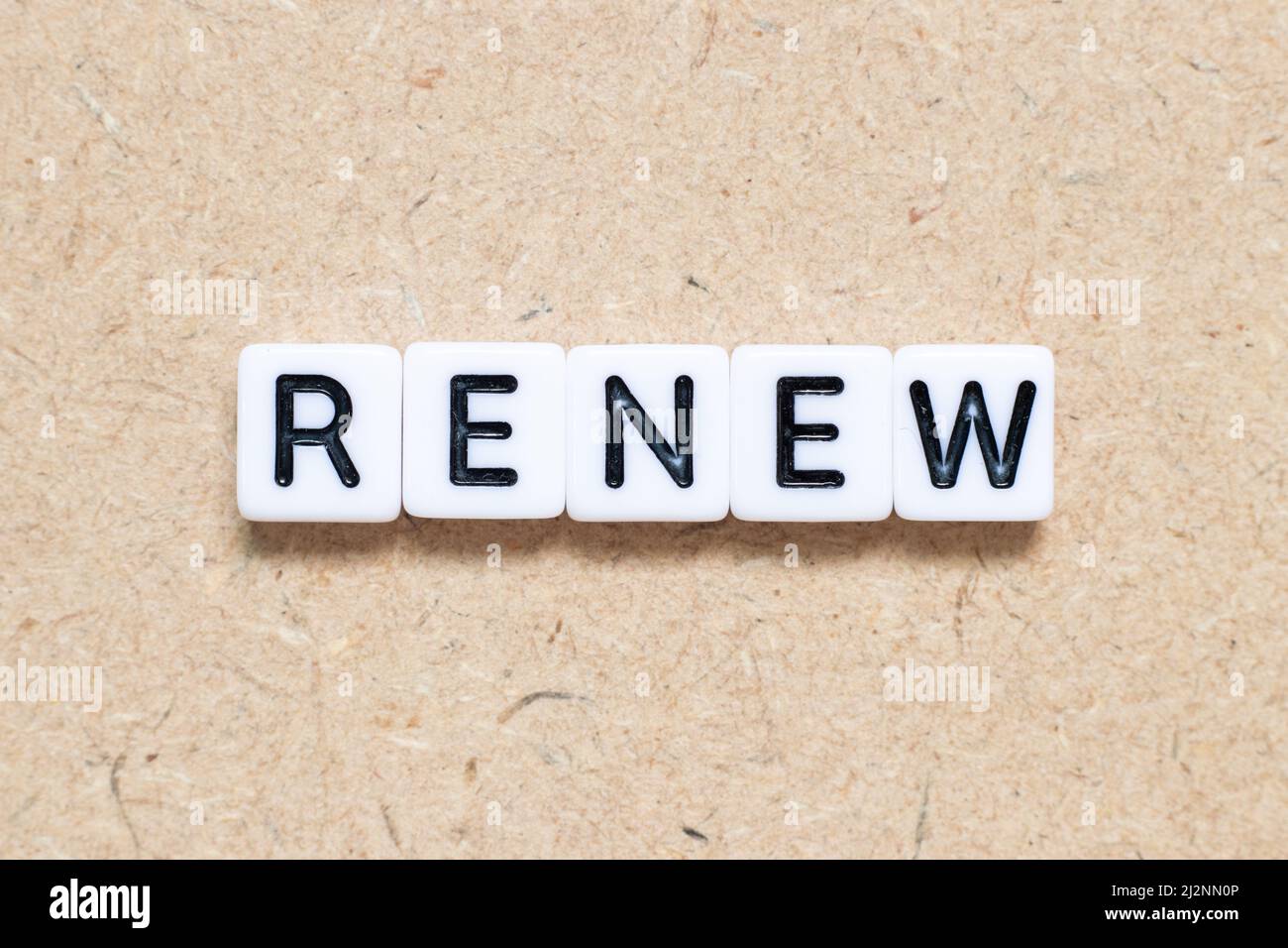 White tile alphabet letter with word renew on wood background Stock ...