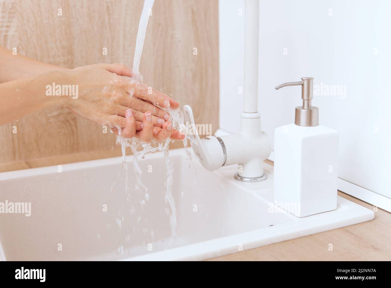 Washing hands under the flowing water tap. Hygiene concept hand detail ...