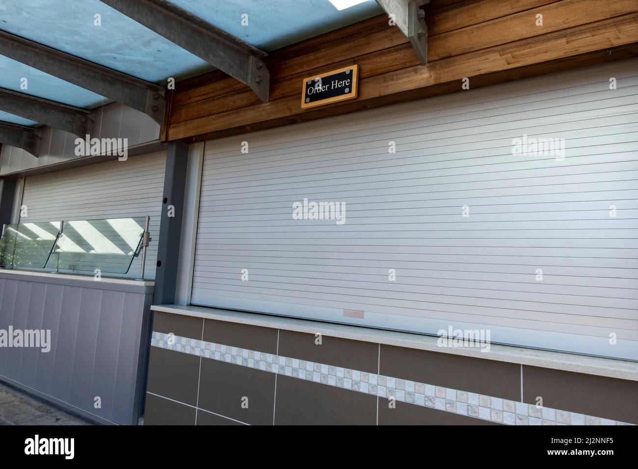 View of a glass sneeze guard protecting customers' food at a closed ...