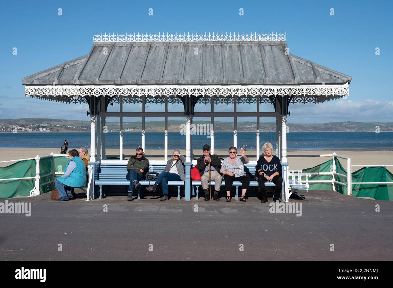 Colourful scenes of holiday-makers relaxing on Weymouth's Esplanade ...