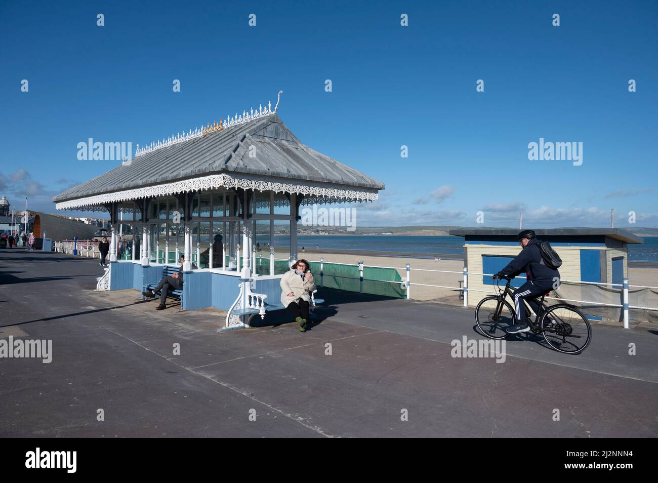Colourful scenes of holiday-makers relaxing on Weymouth's Esplanade ...