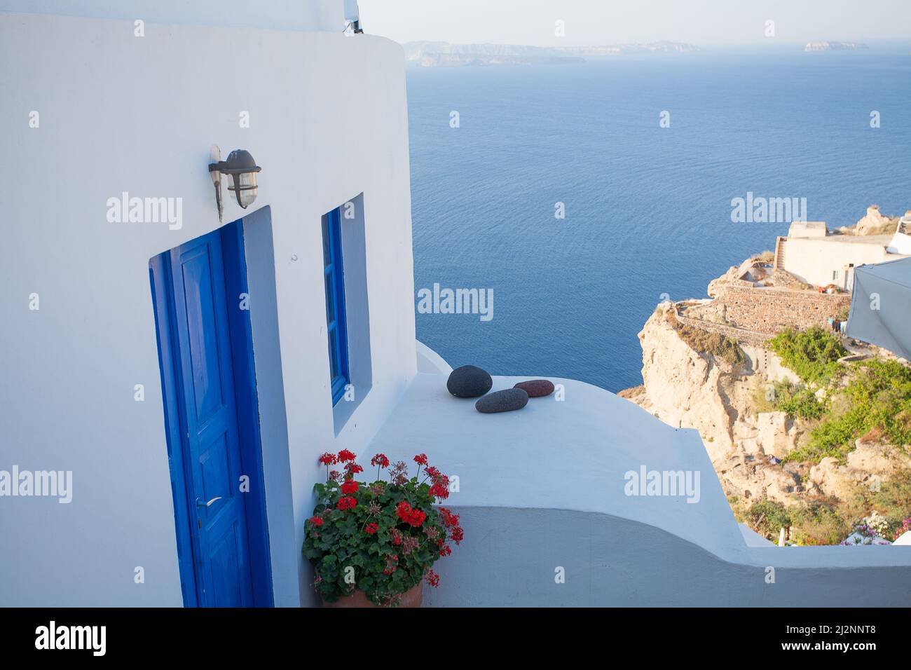 Old blue door and red flowers, traditional Greek architecture ...