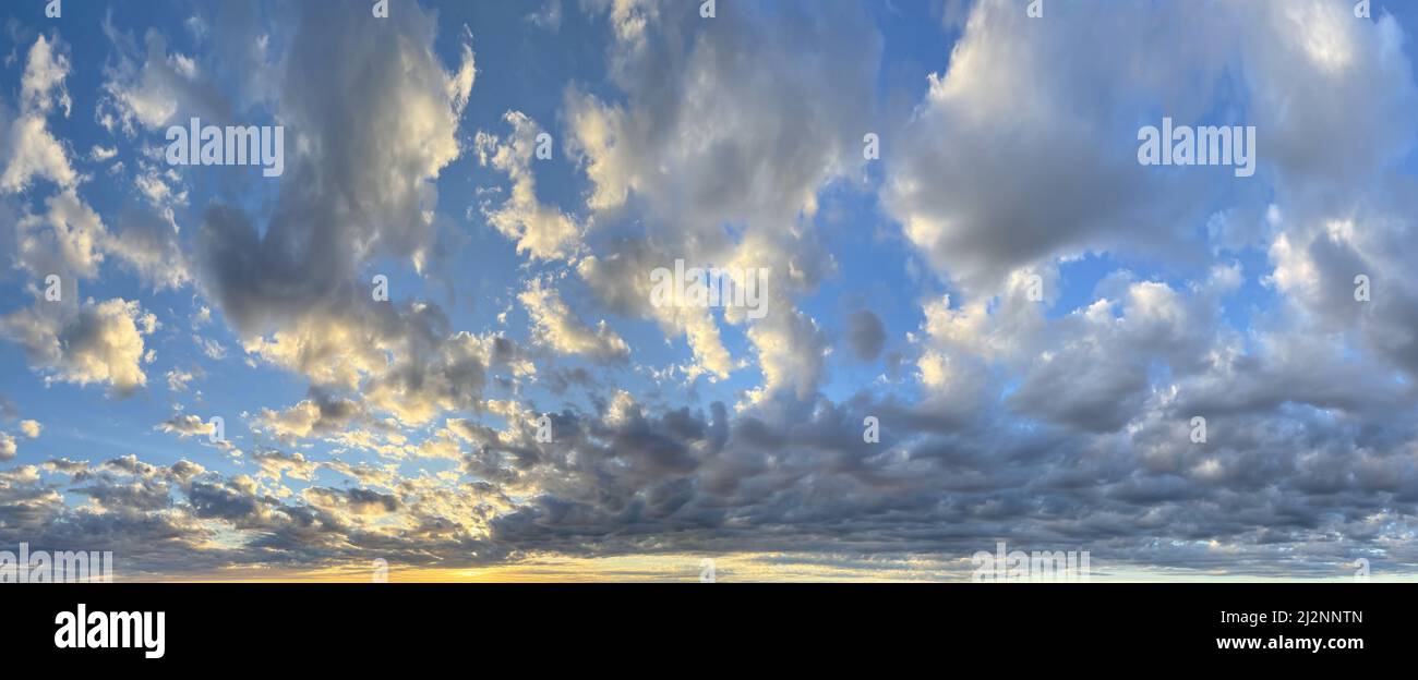 Sunset sky panorama. Clouds, sky and sun light Stock Photo - Alamy