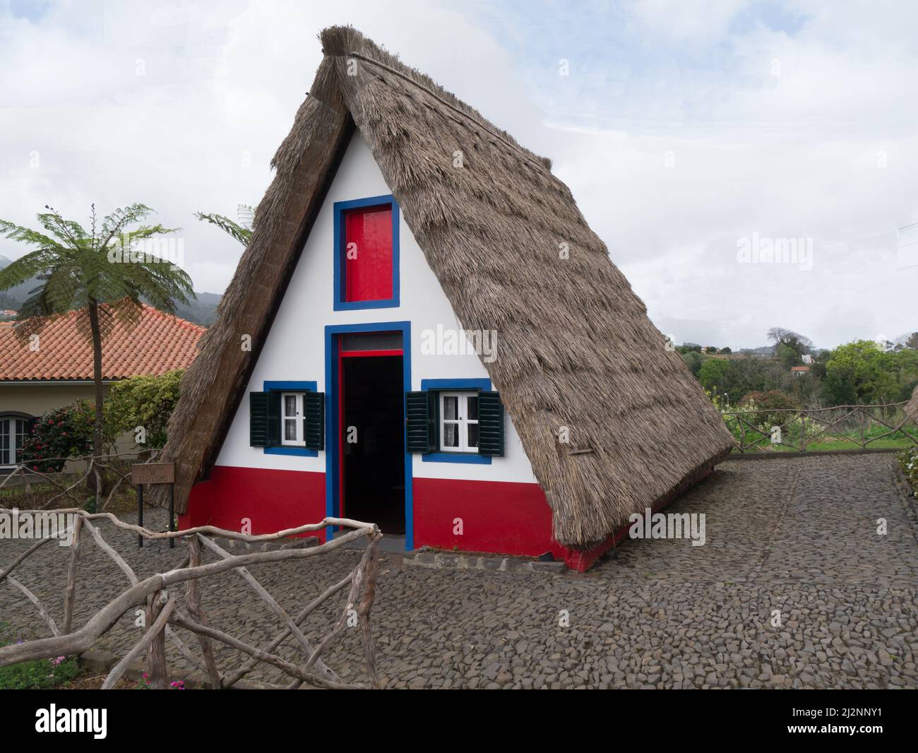 Houses constructed with sloping triangular straw covered rooftops hi ...