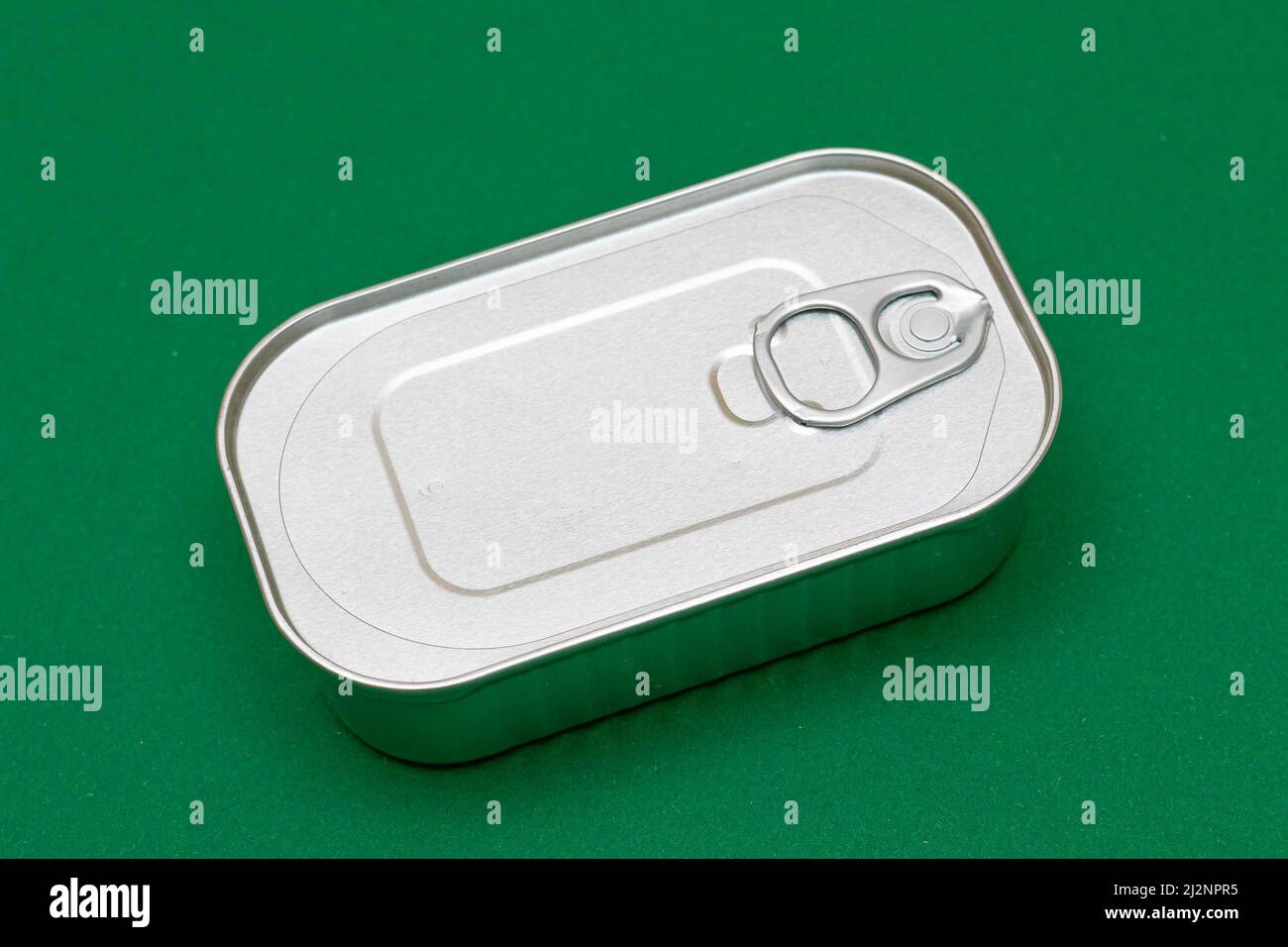 Unopened Tin Can with Blank Edge on Green Background. Canned Food ...