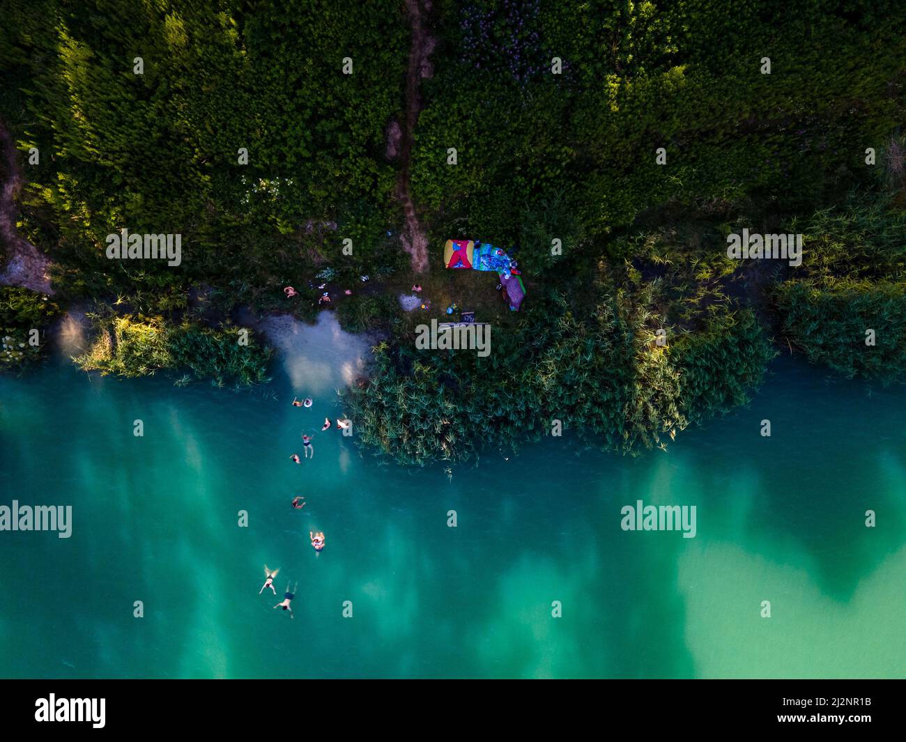 overhead view of leak beach blue water. people having fun swimming ...