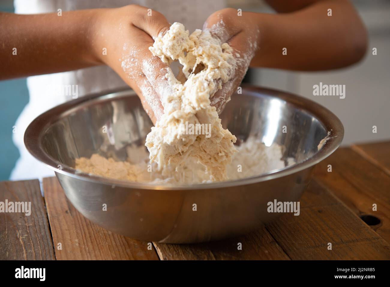 Funny African-American girl cooking a dessert in the kitchen of her ...