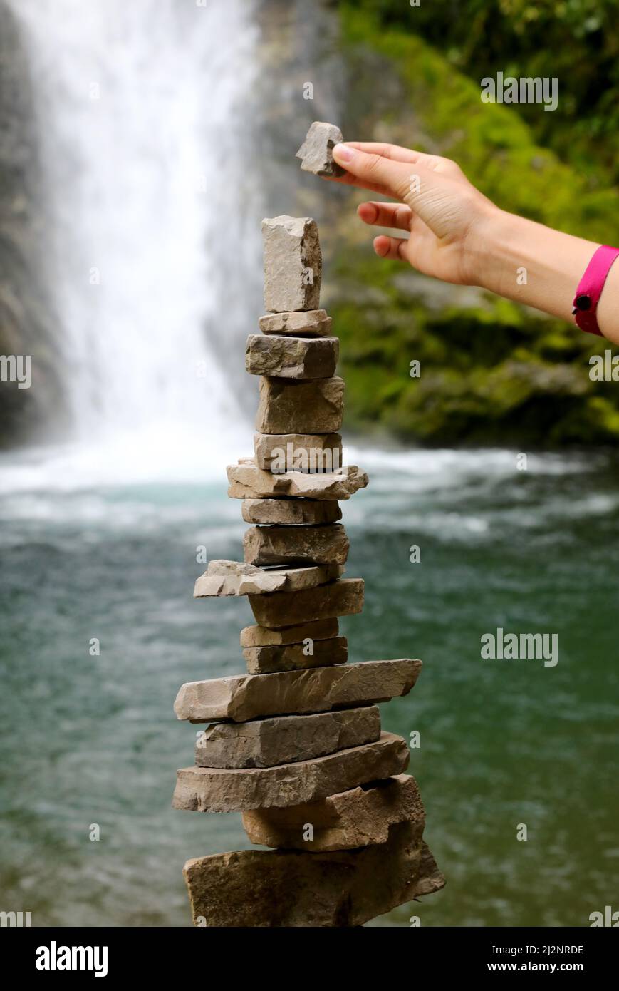 hand that puts stones on top of a pile is this pile of stones is called ...