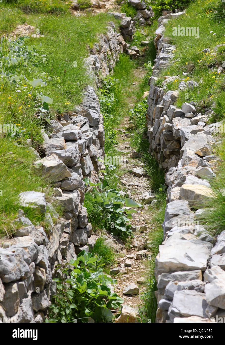old trench made of stones dug into the ground during the first world ...
