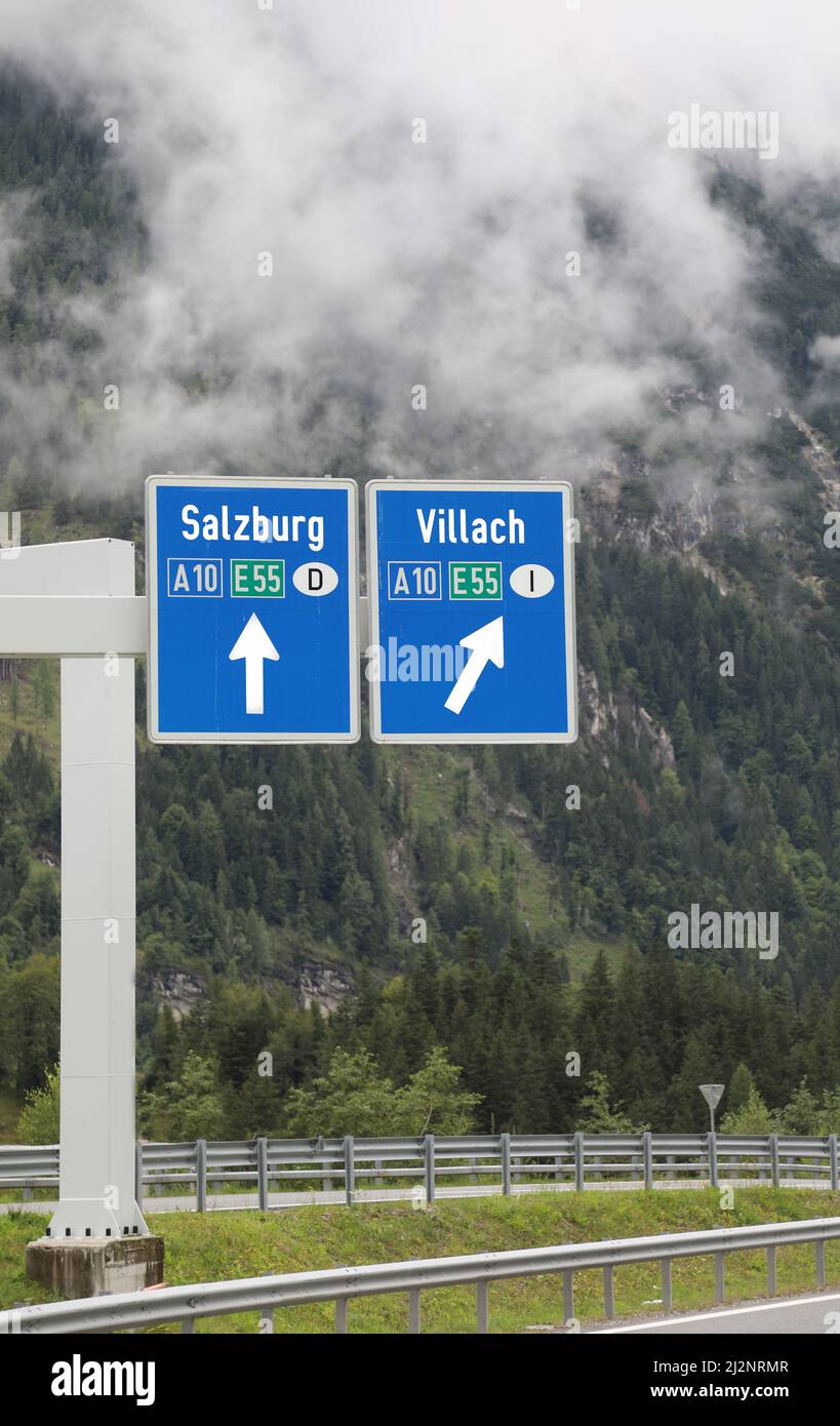 motorway junction with large signs indicating the border cities of ...