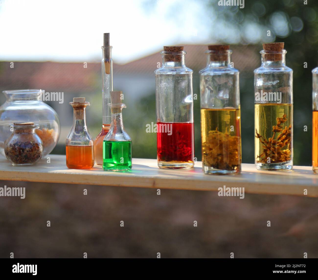 many galss small bottles with colored liquids that can be used as ...