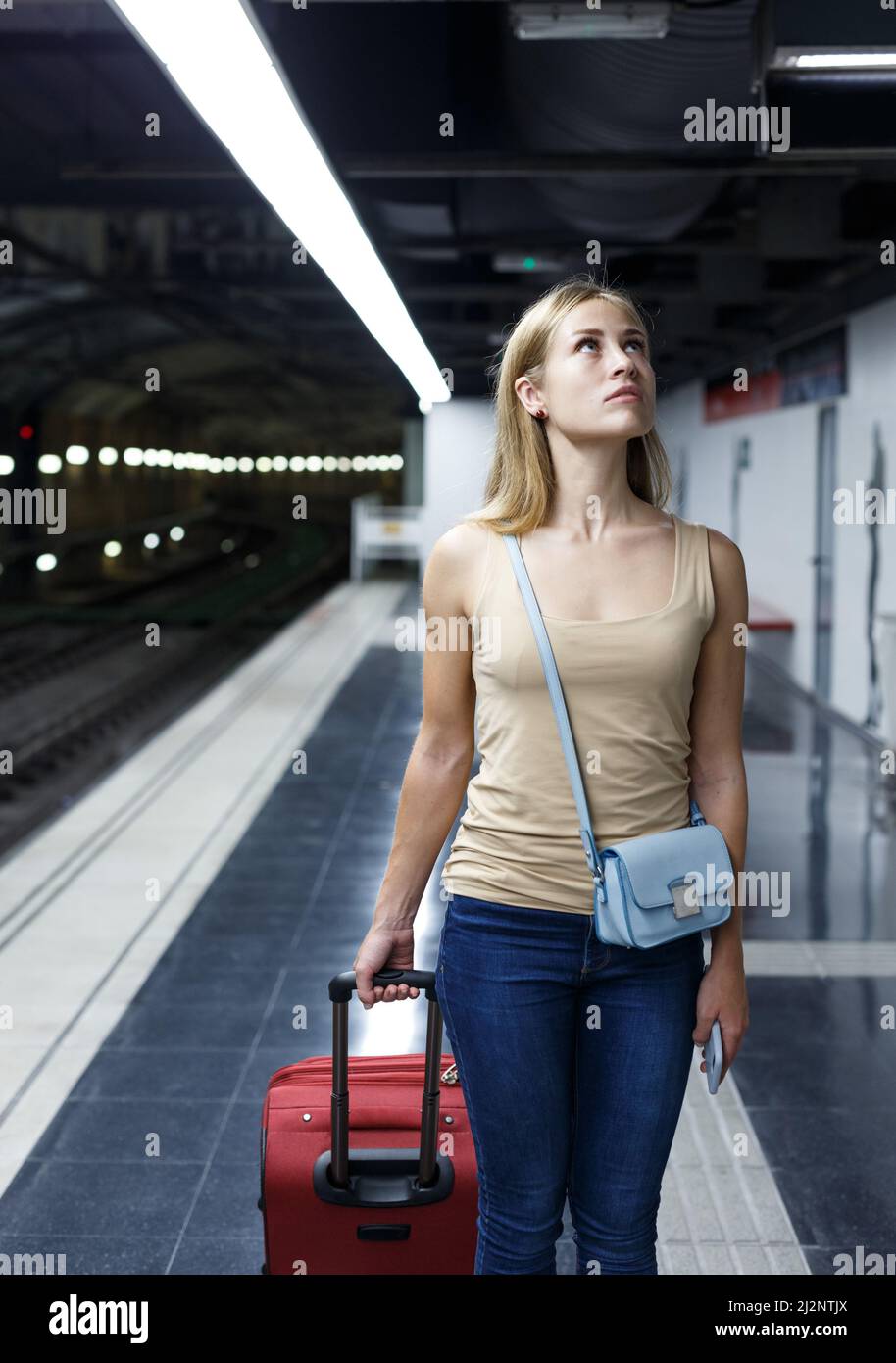 Woman on underground platform waiting train Stock Photo - Alamy
