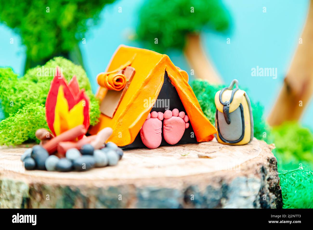Tourist camp. Plasticine landscape with a tent, a campfire and a ...