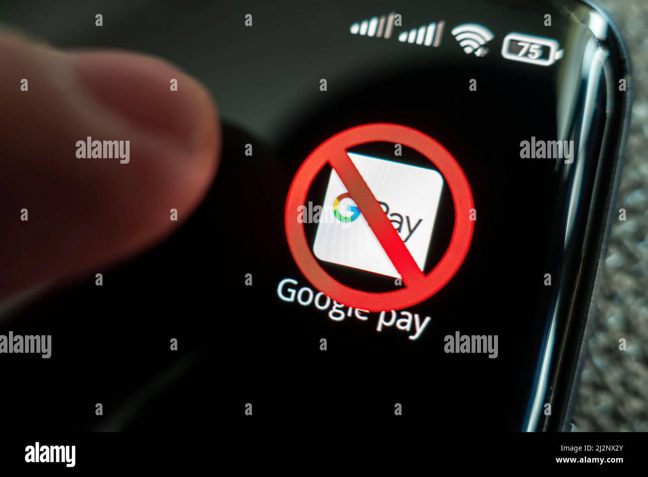 A crossed-out icon on a black smartphone screen. the concept of banning ...