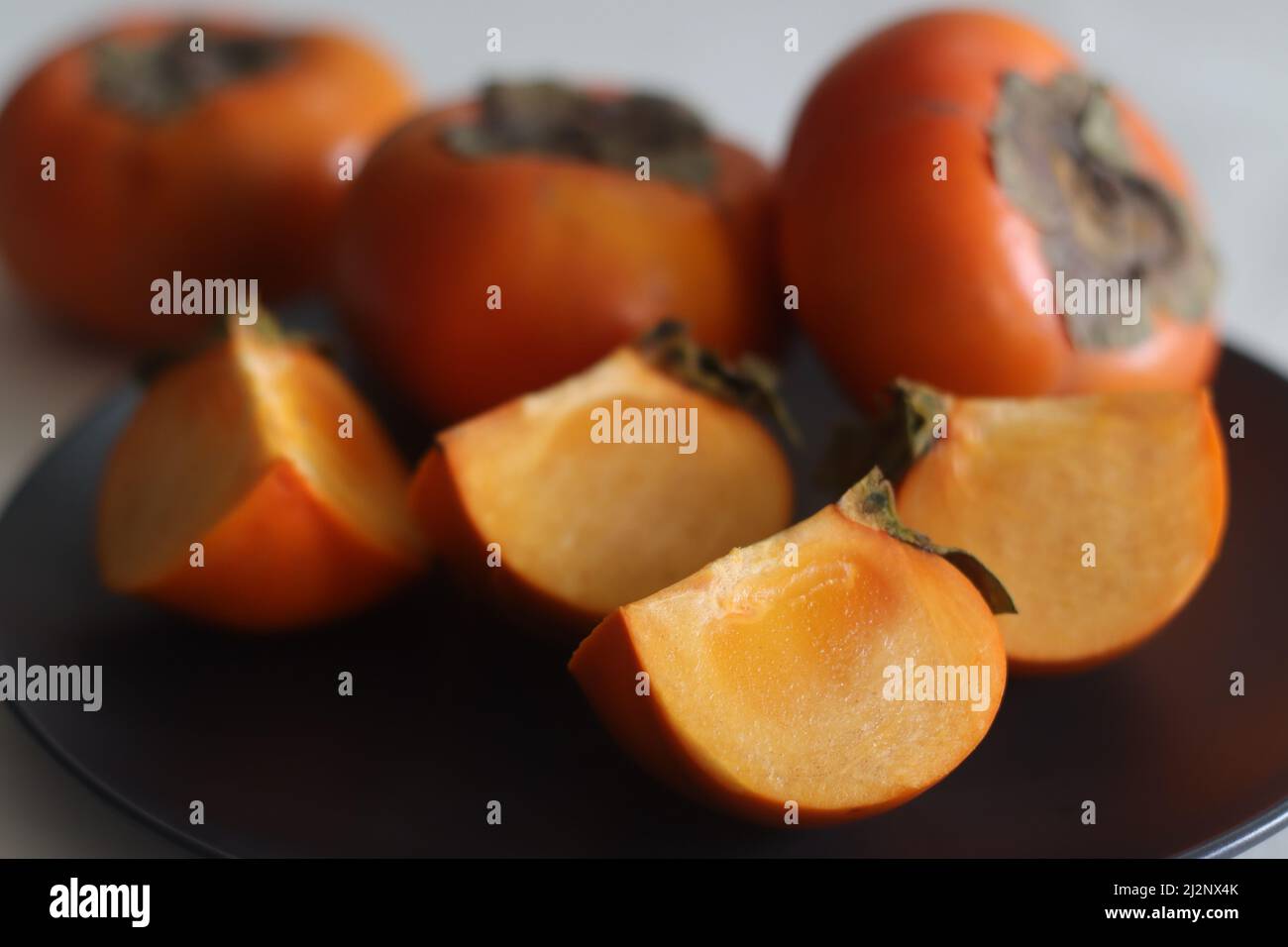 Sliced amarphal. Persimmon or amarphal is a fruit native to Japan ...