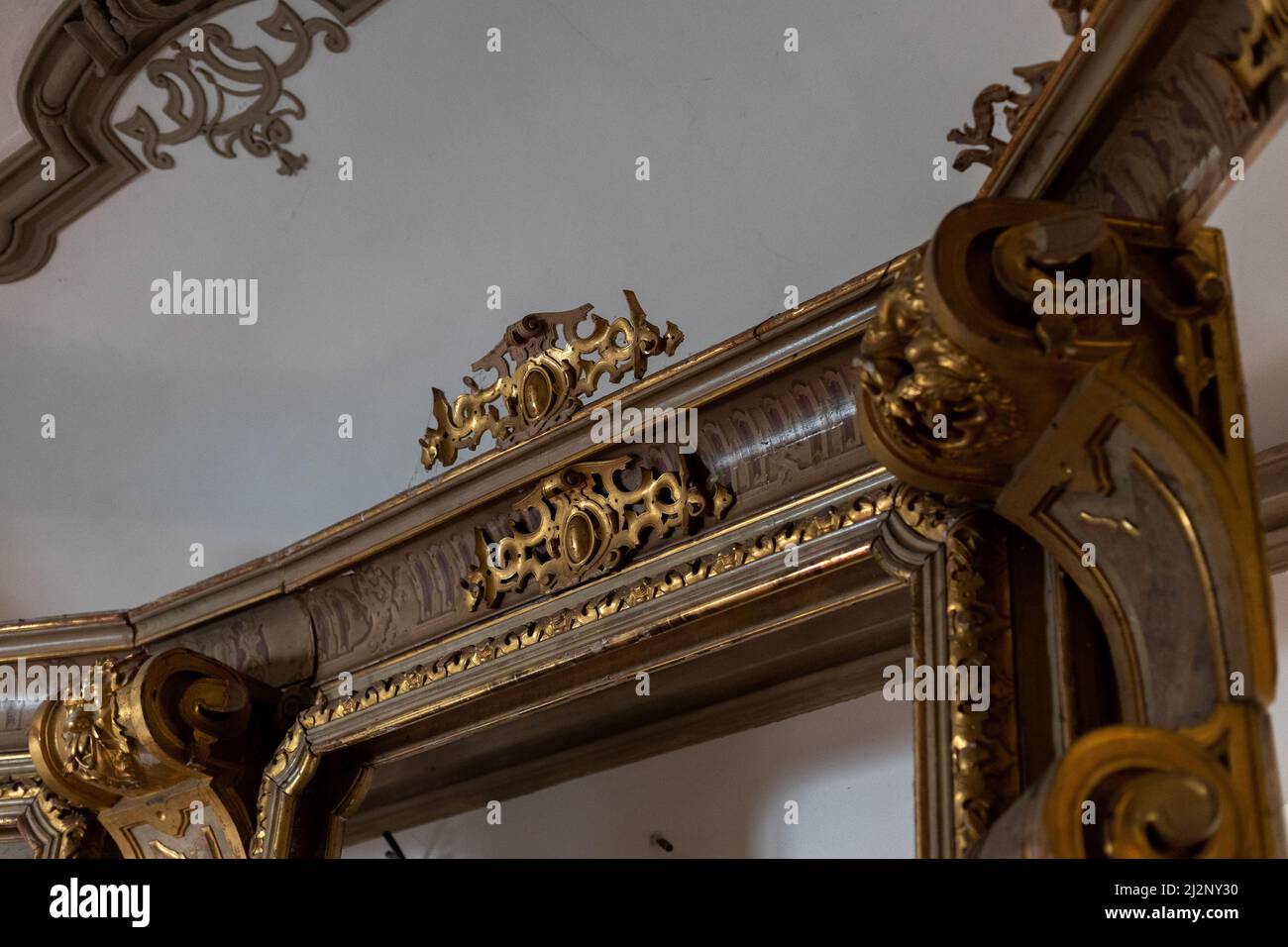 an old gothic gold frame wall decor in old architecture Stock Photo - Alamy