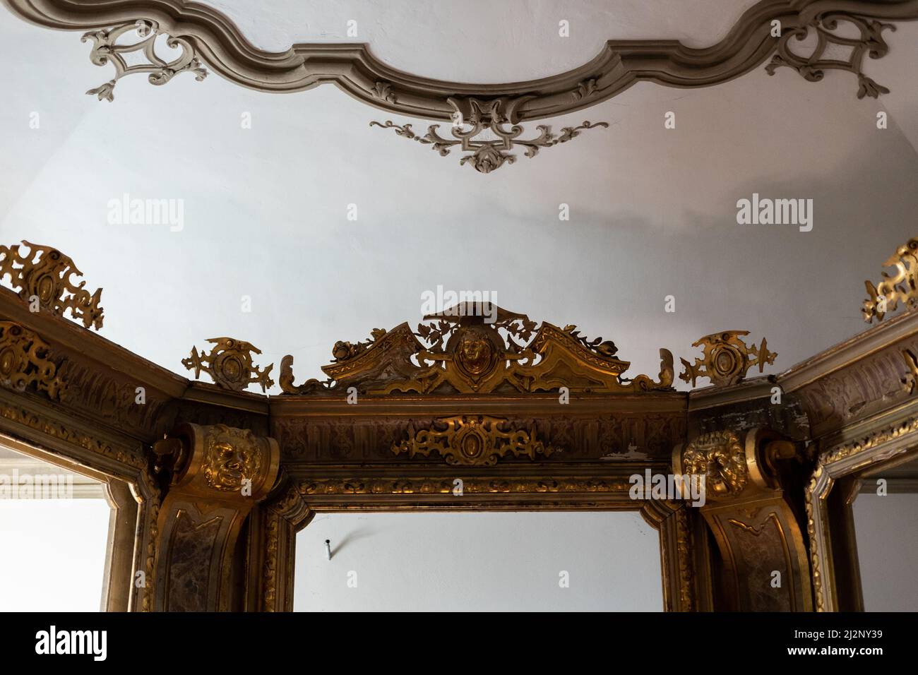 an old gothic gold frame wall decor in old architecture Stock Photo - Alamy