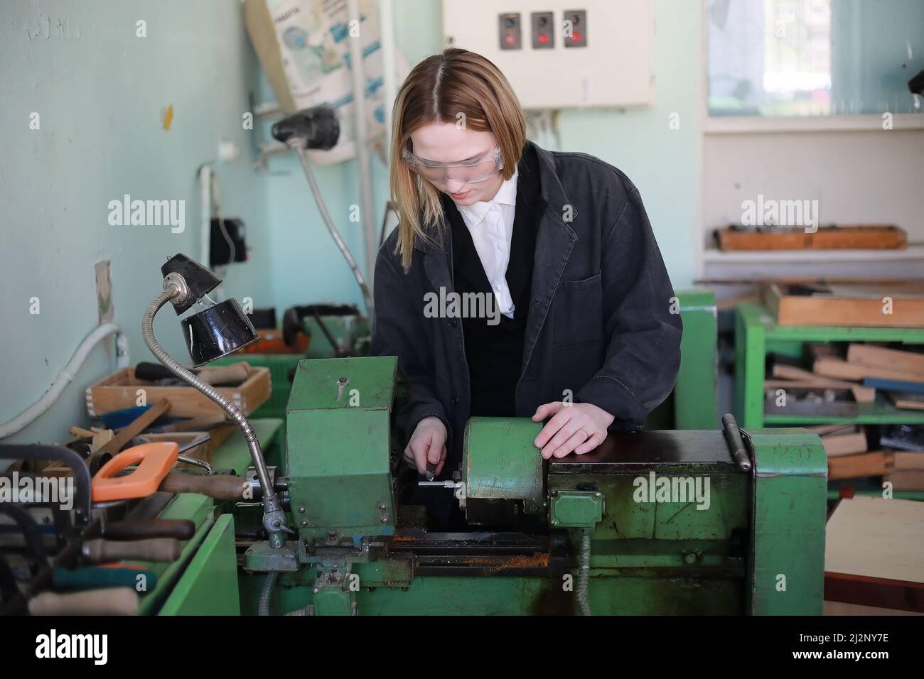 Young woman engineer working at machine tool manufacturing Stock Photo ...