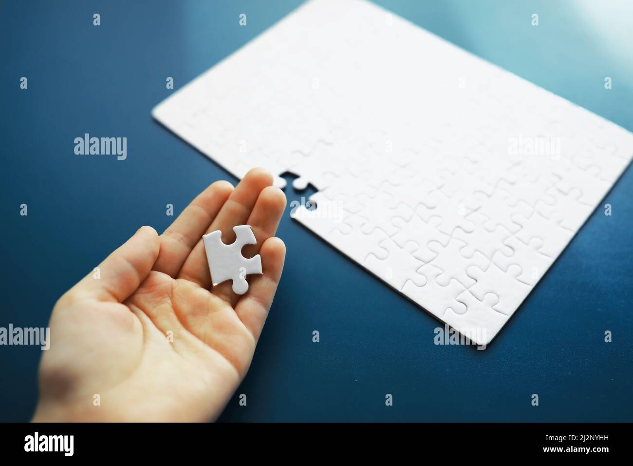 Intellectual puzzles. The puzzle empty. The hand puts together puzzle ...