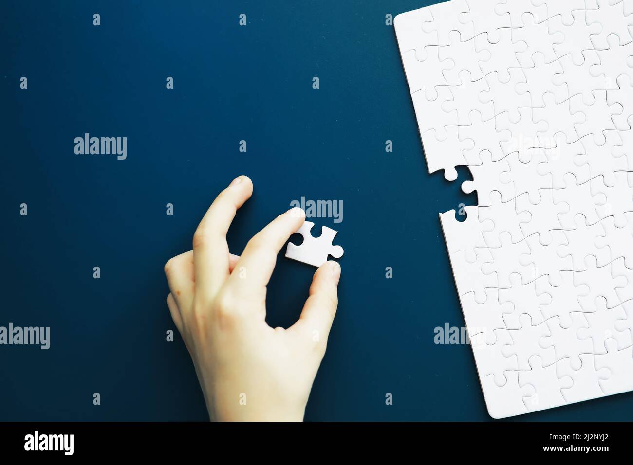 Intellectual puzzles. The puzzle empty. The hand puts together puzzle ...