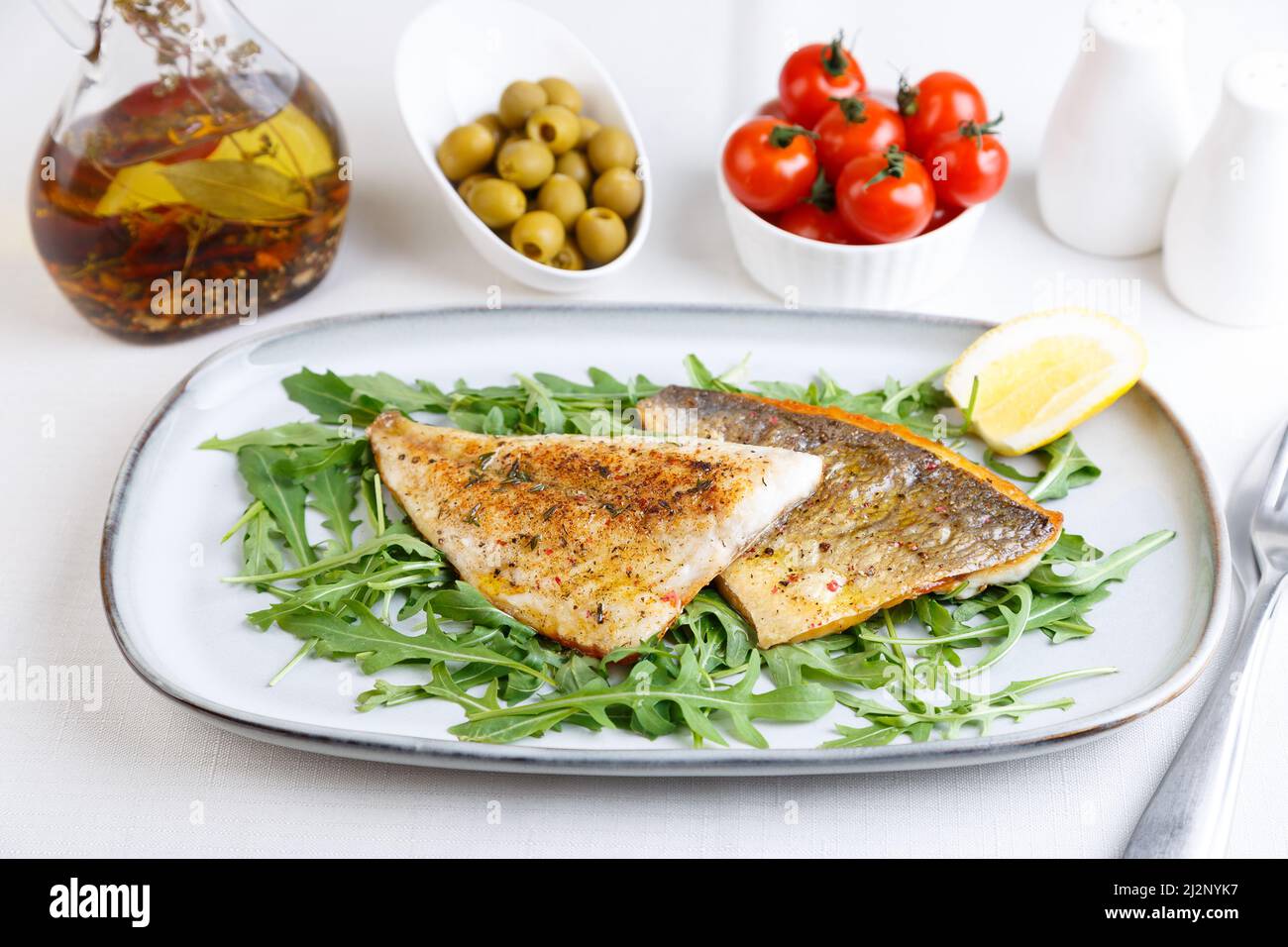 Fried dorado fillet with crispy skin. Arugula, cherry tomatoes, olives ...